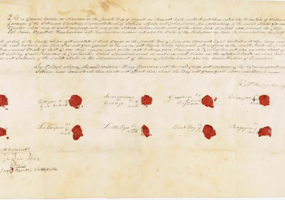 Yatay parşömen kağıdı üzerinde, 11 imzalı ismin yanında kırmızı mum mühürler ve düzgün, eğimli el yazısıyla yazılmış üç paragraf metin içeren bir anlaşma