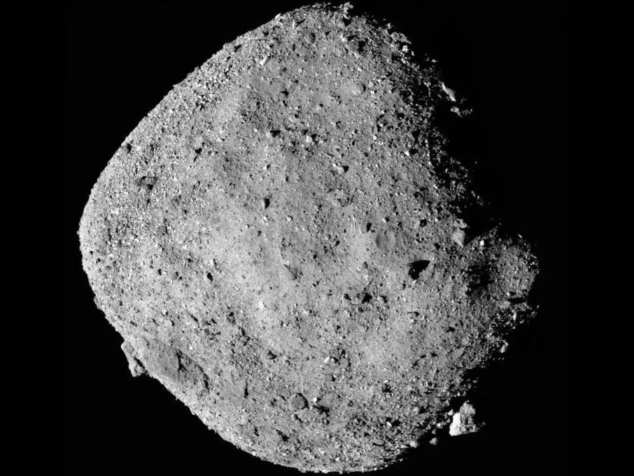 A composite image of asteroid Bennu with a shadow on its right