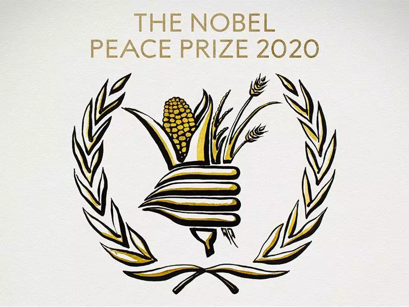 Uma ilustração em preto e branco de uma reunião de alimentos - milho, trigo, cercada de louros - com o texto THE NOBEL PEACE PRIZE 2020, com detalhes em ouro