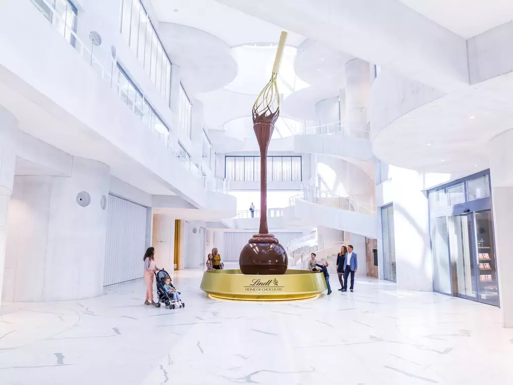 Ingången till Lindt Home of Chocolate inkluderar en 30-fots chokladfontän toppad med en gigantisk gyllene visp