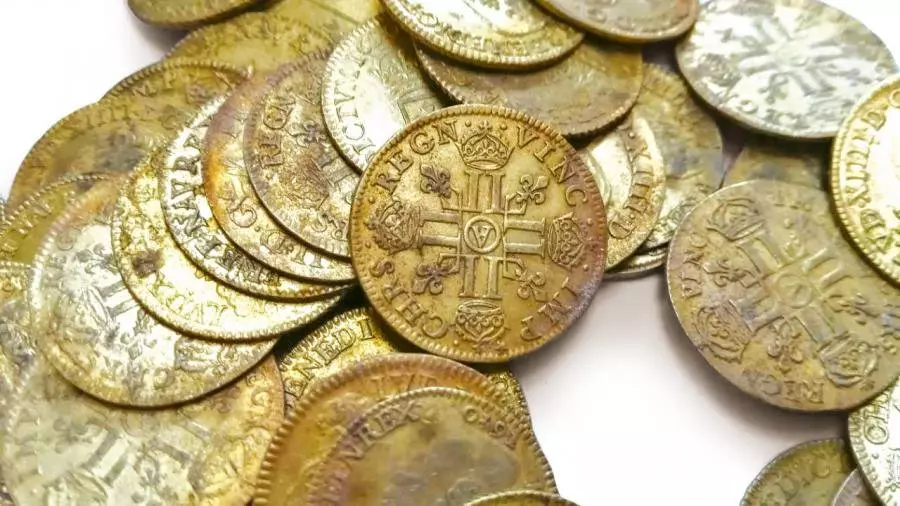 A close up shot of a pile of gold coins