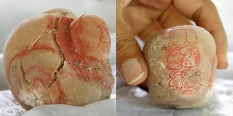 The carved alabaster vessel (shown from two sides) found in the burial chamber.