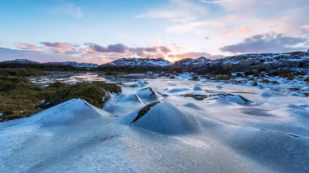 Paisaje rocoso cubierto de hielo al amanecer.