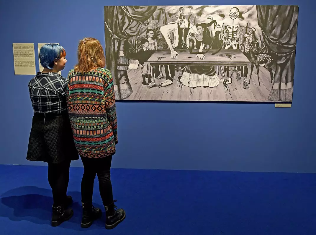 Museum visitors look at a black and white reproduction of La Mesa Herida in the ZAMEK Culture Centre in Poznan, Poland