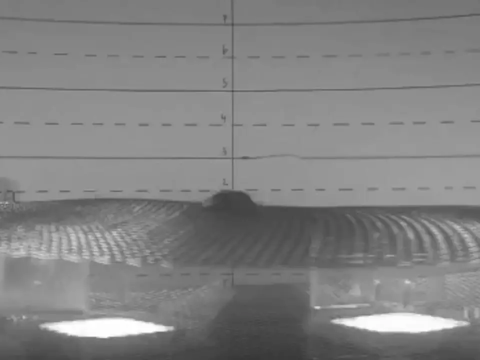 An video shows two microflyers levitating in a vacuum chamber