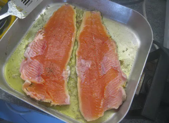 Ganjaran fishing trout: fillet seasoned simmering dina minyak zaitun.