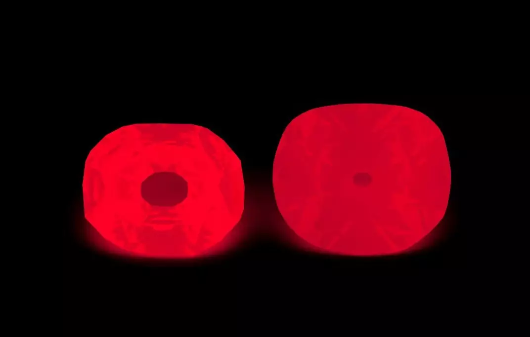 Duas gemas brilhando em vermelho no escuro.