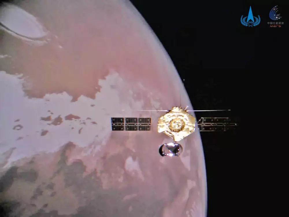 En bild av Tianwen-1 orbiter som kretsar ovanför Mars yta