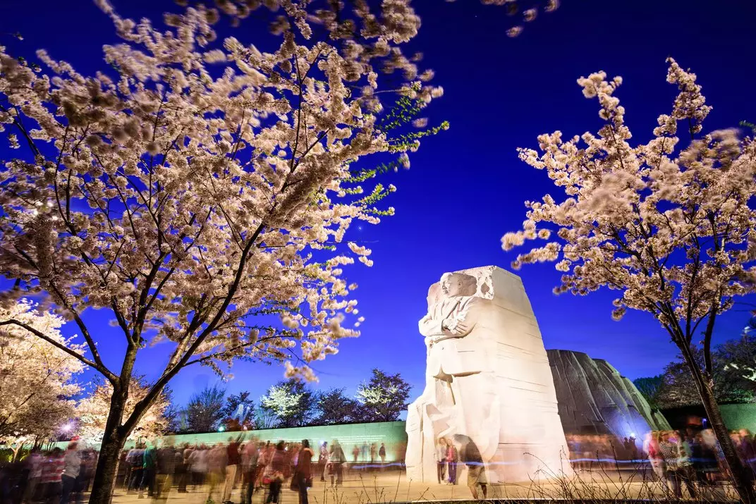 Pelancong berkumpul di bawah Memorial Martin Luther King, Jr. di West Potomac Park.