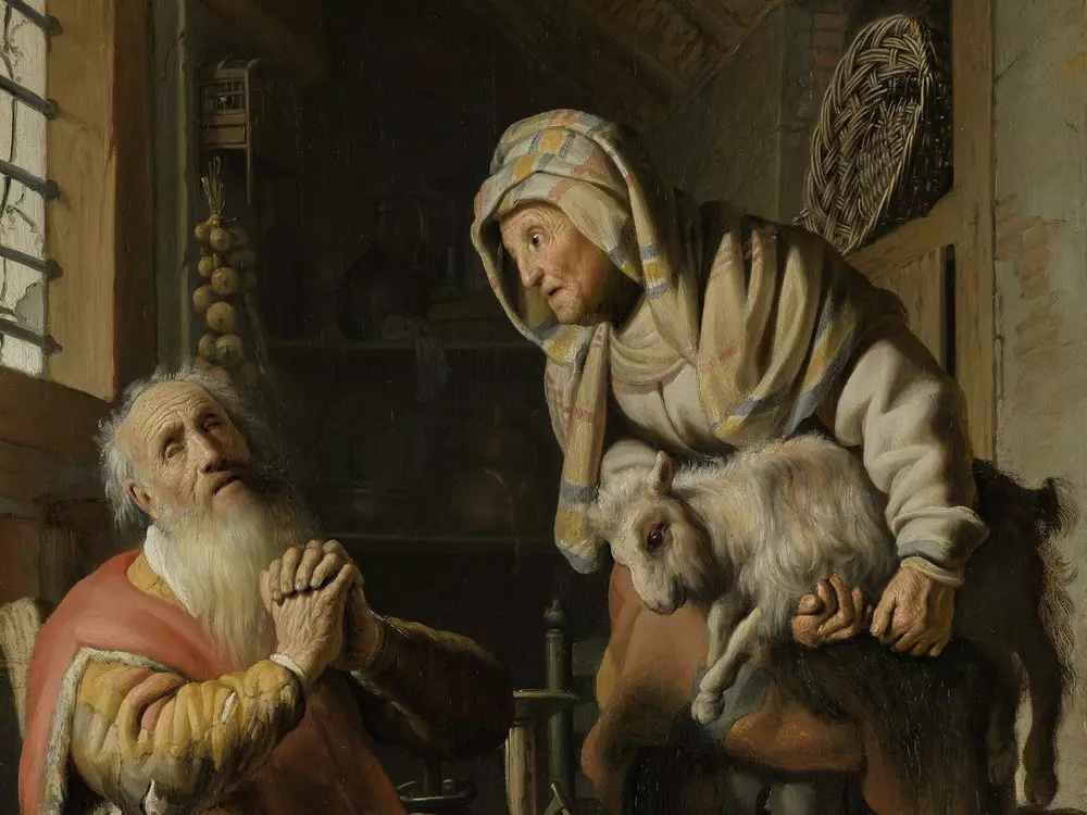 Slika starejšega moškega, ki moli, medtem ko ženska govori z njim in drži kozlička